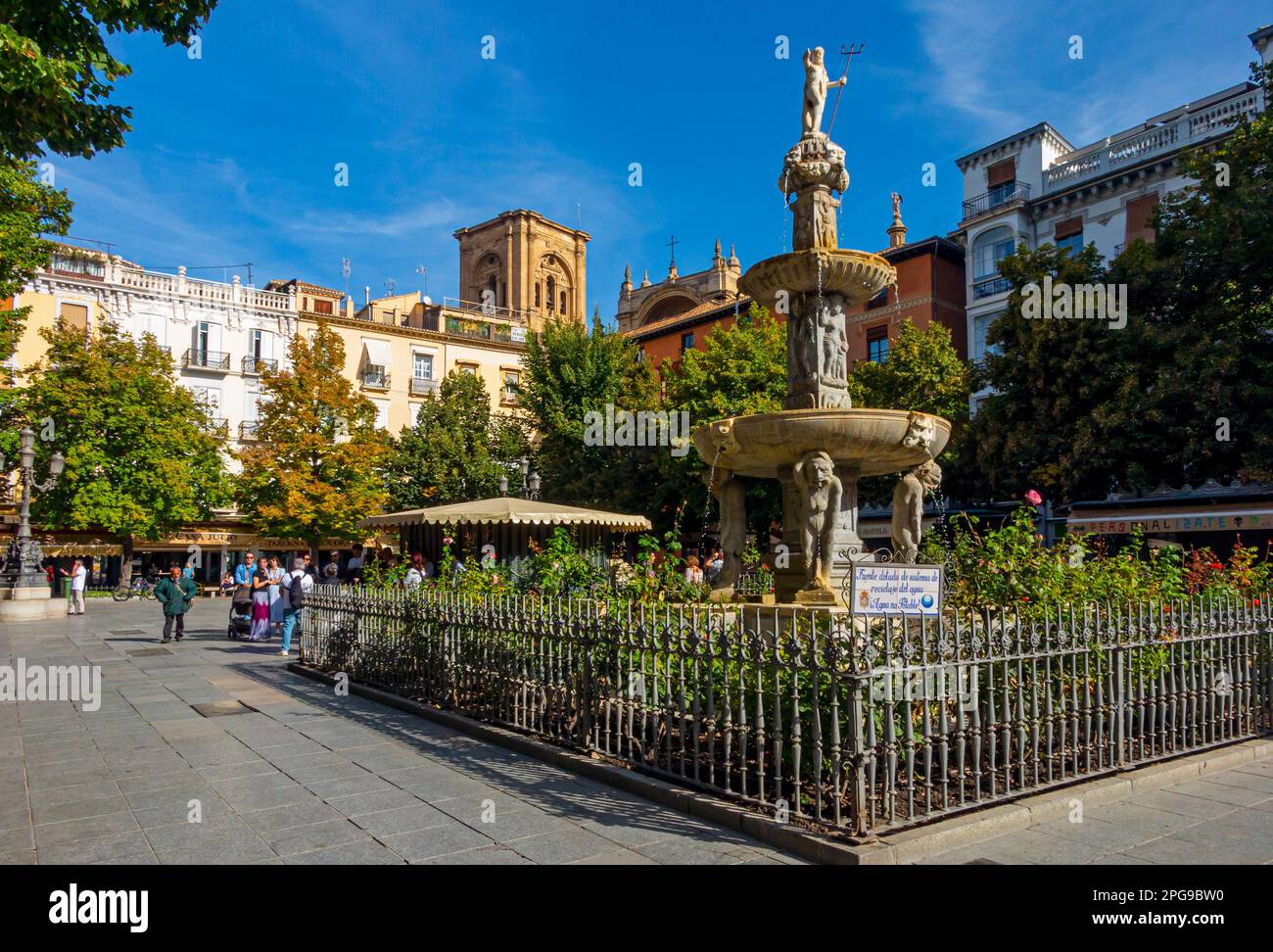 Fountain in a public square with the cathedral tower in the background ...