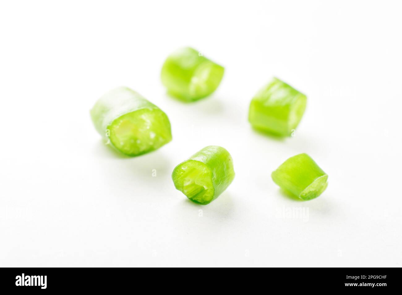 Chopped green chilli on white background Stock Photo - Alamy
