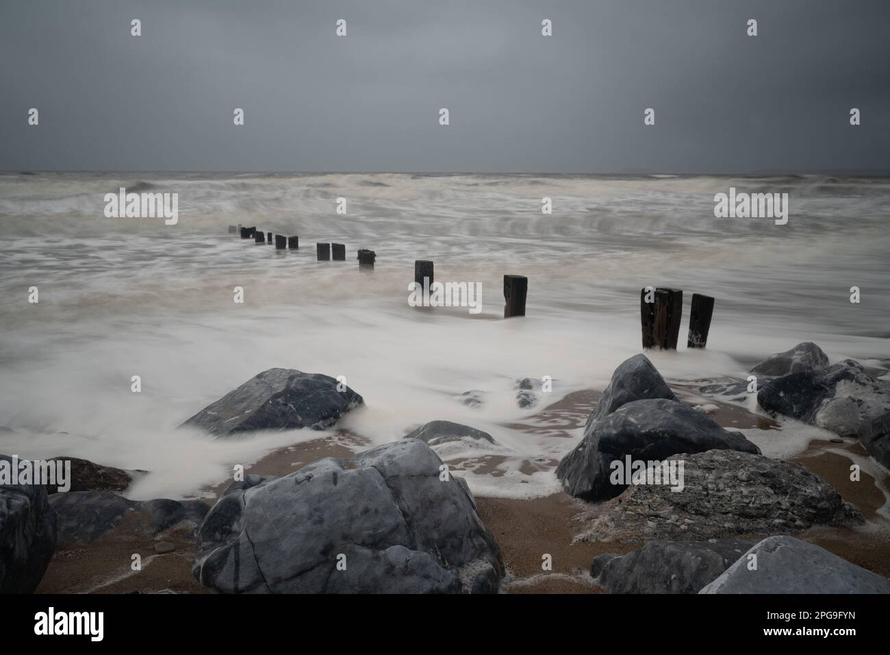 Breaking waves merging with sea foam (Spume) on a stormy evening on ...