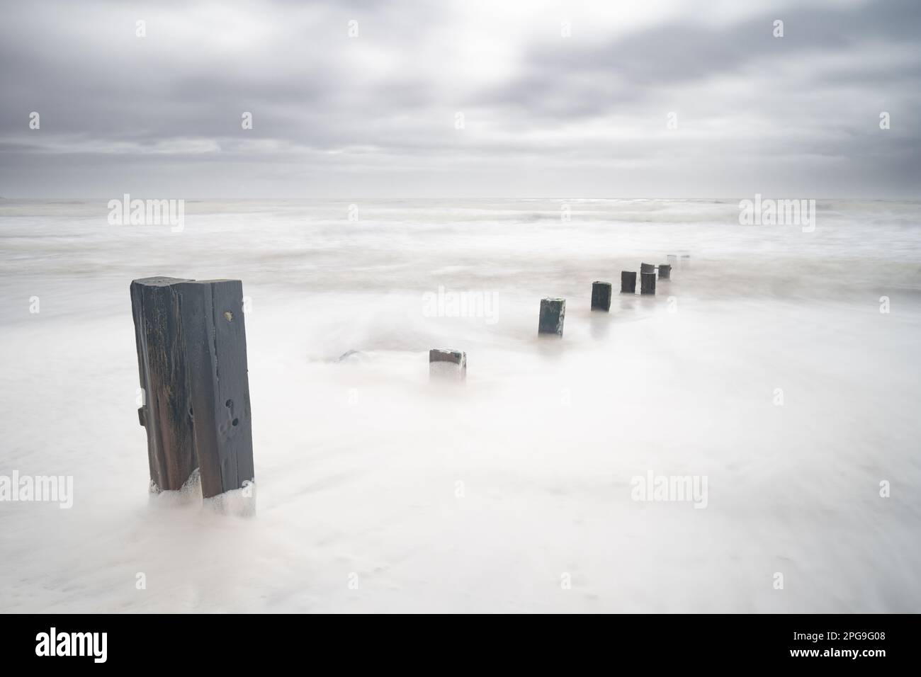 Breaking waves merging with sea foam (Spume) on a stormy evening on ...