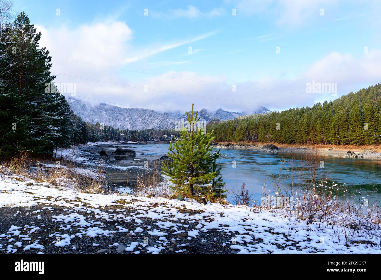 Stone banks on the autumn river Katun in the mountains with snow and ...