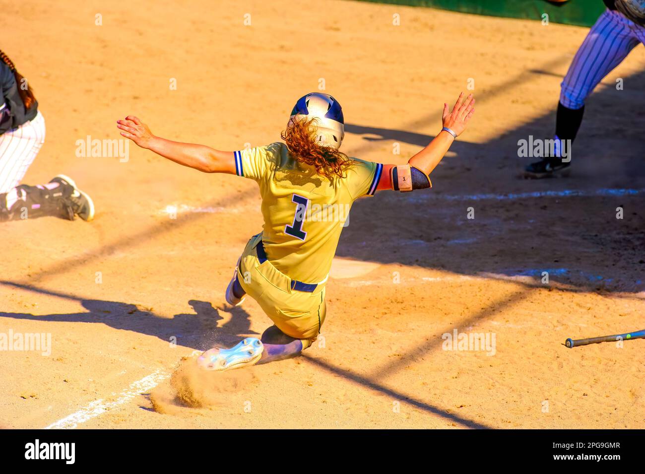 Girl softball player sliding into base hi-res stock photography and ...