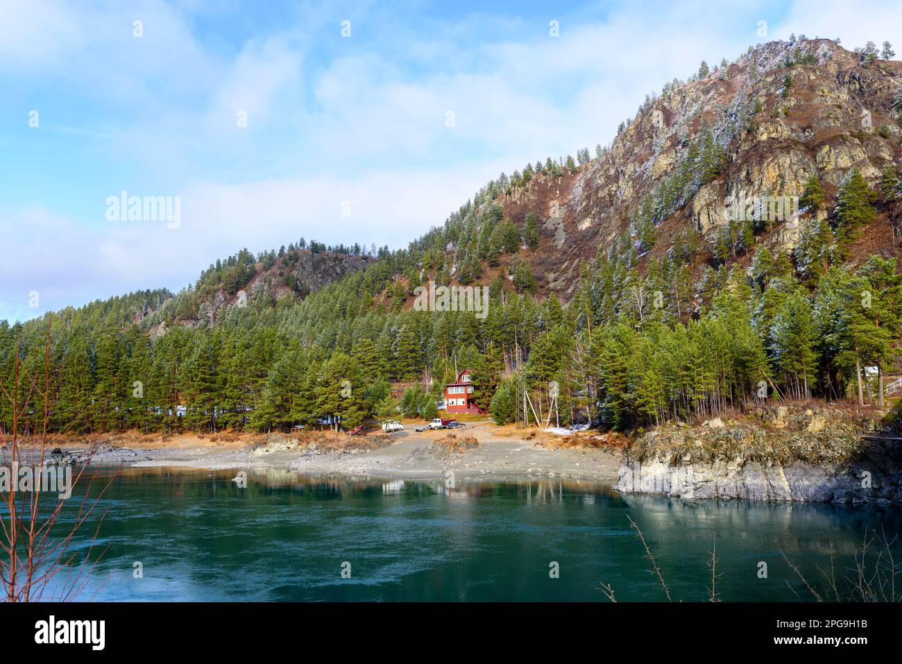 Stone banks on the autumn river Katun in the mountains with snow and ...