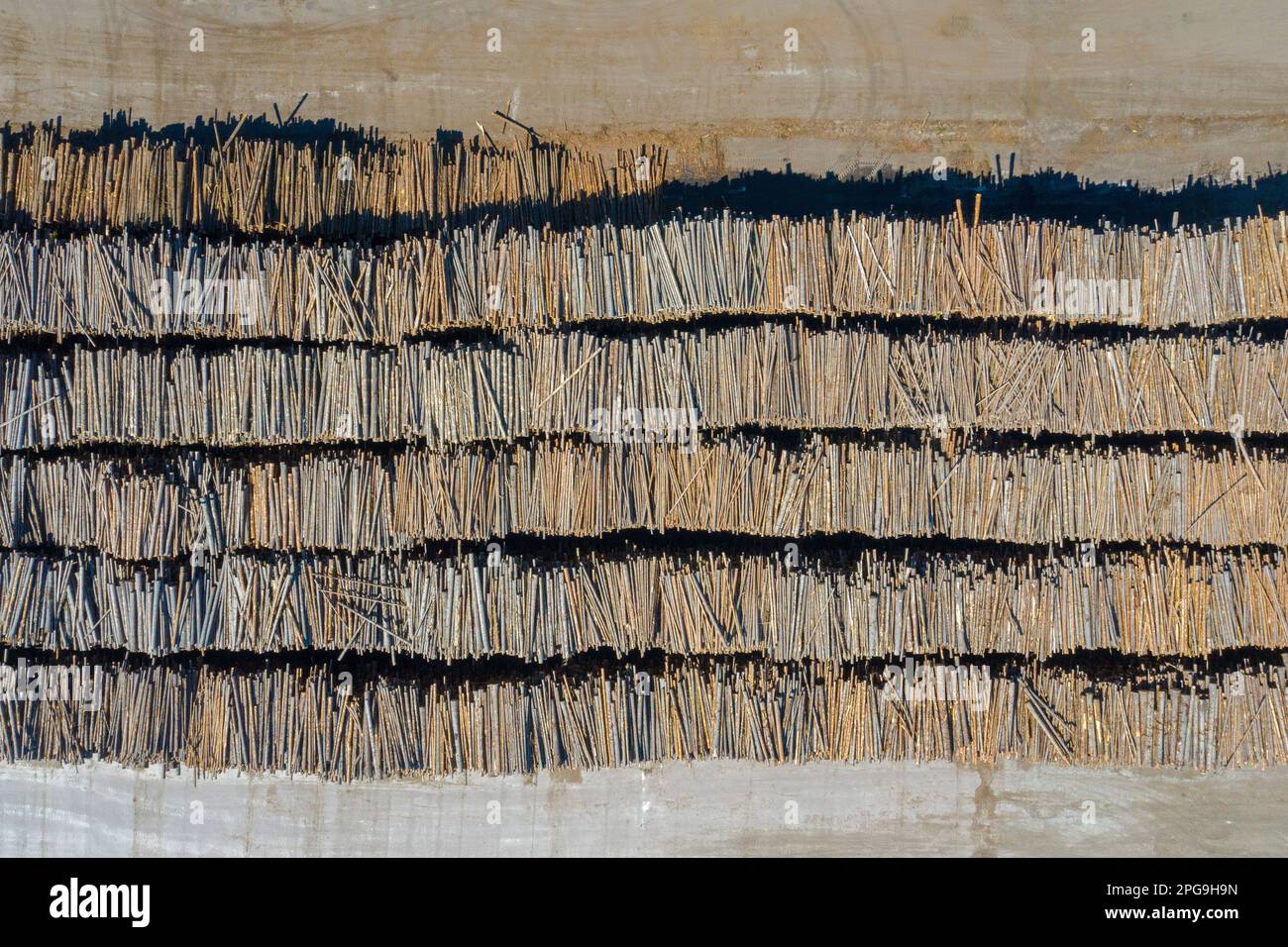 Aerial view over stacked tree trunks / wood piles at paper mill and ...