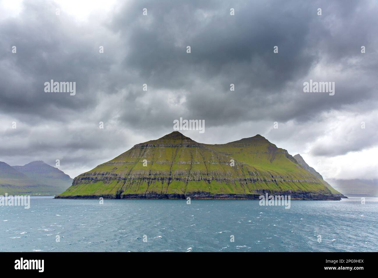 Sea cliffs along the rugged coast of Eysturoy / East Island, region and ...