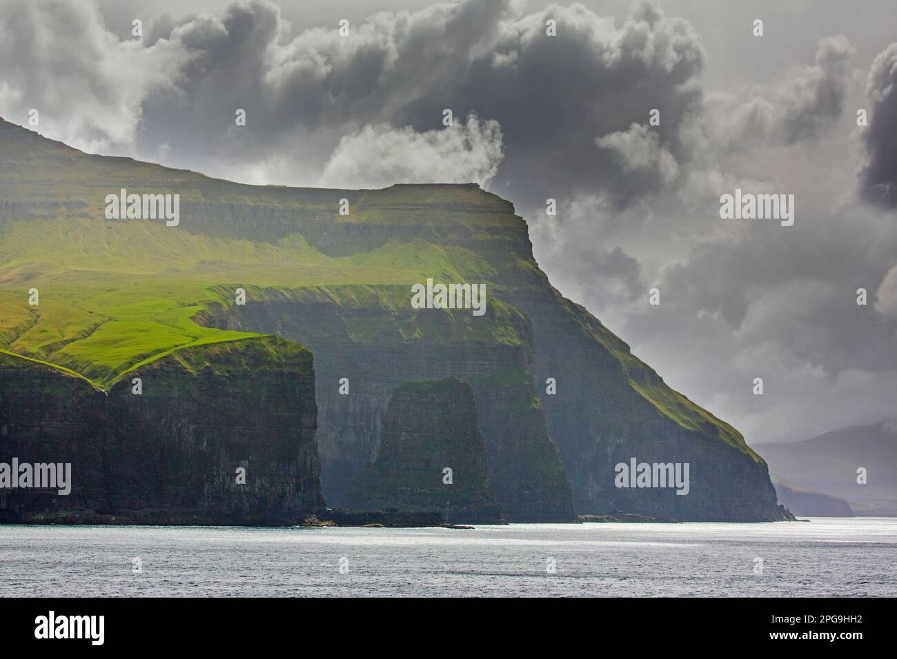 Sea cliffs along the rugged coast of Eysturoy / East Island, region and ...