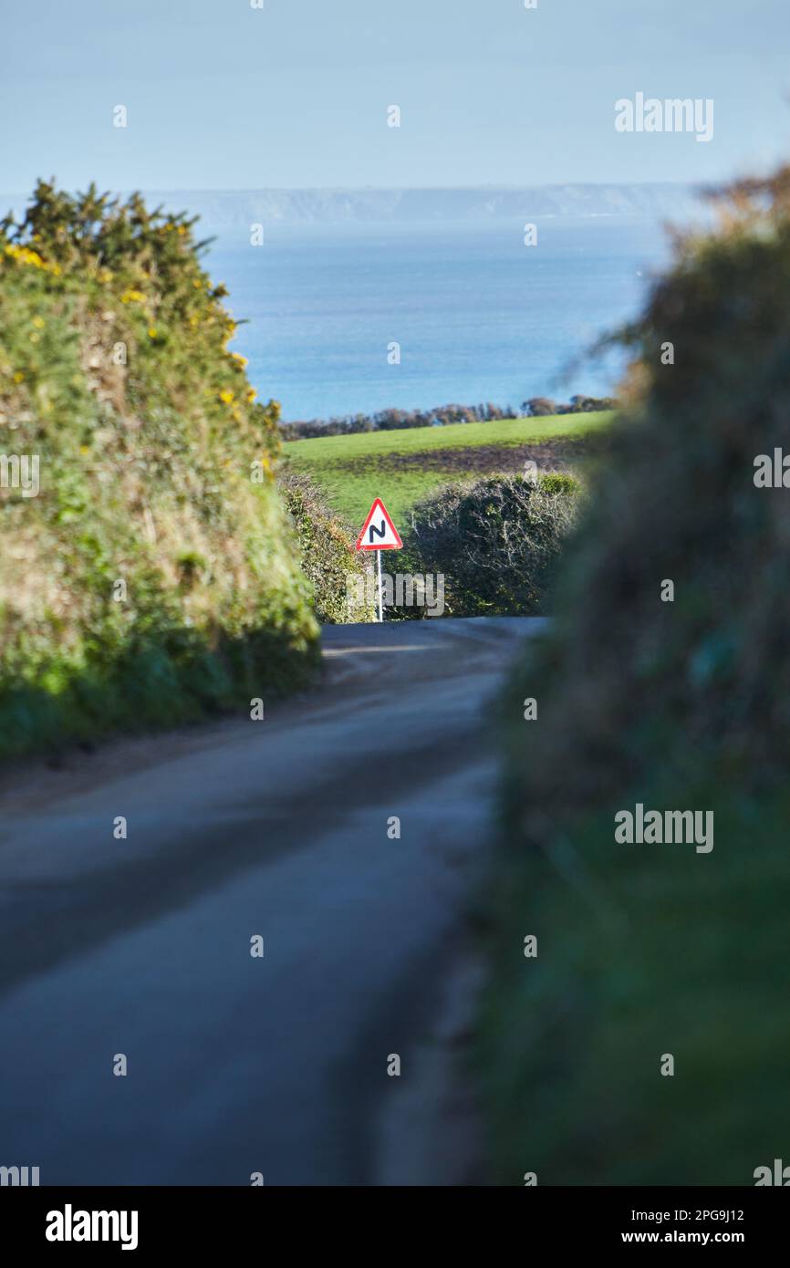 Cornwall, UK - Traffic sign warning of curvy road ahead in typical ...