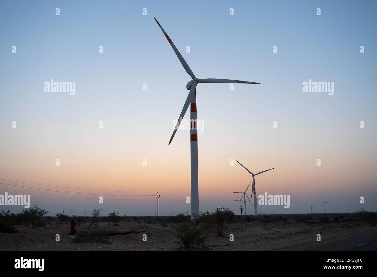 Pre dawn light in desert sky with Electrical power generating wind ...