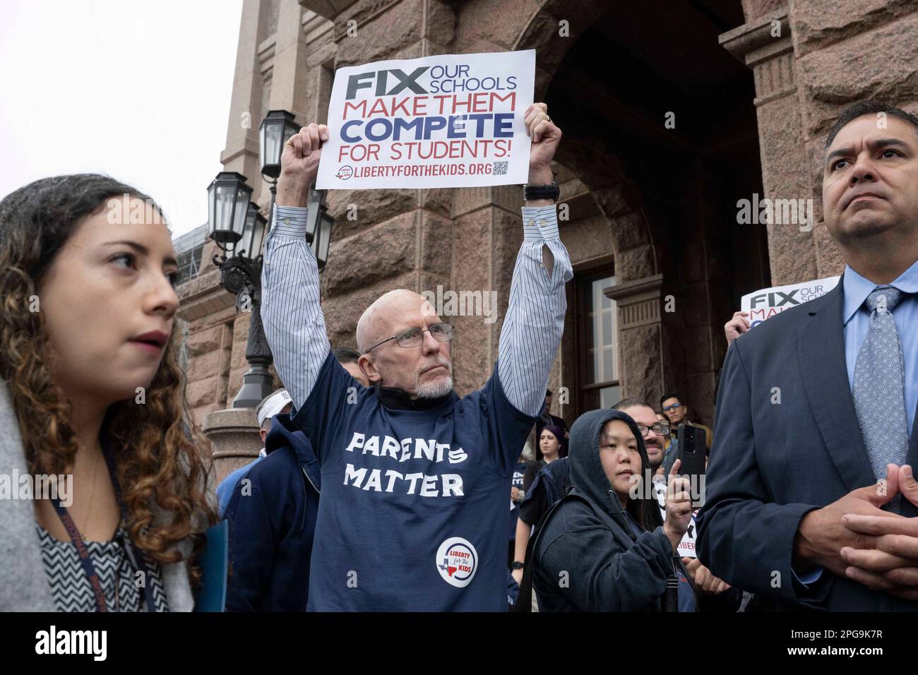 Austin Texas USA, March 21 2023: A man holds a sign as Texas Gov. Greg ...