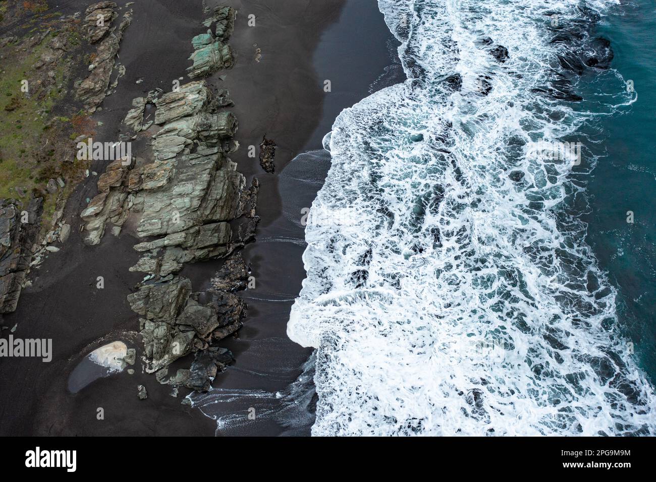 Aerial view of chilean ocean with black snd beach. Top view from drone ...