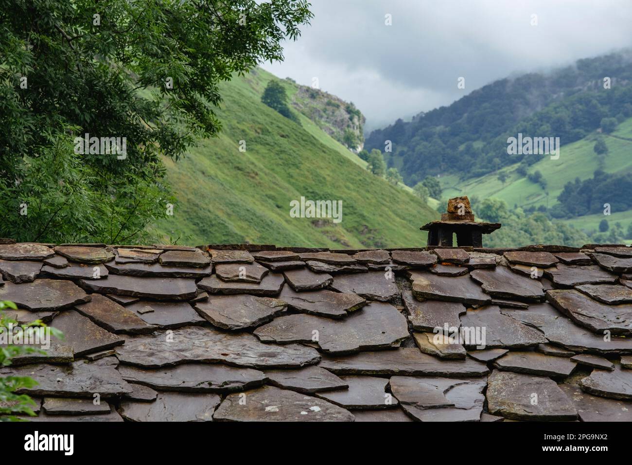 Traditional slate roof and chimney of a rustic traditional cabin in the ...