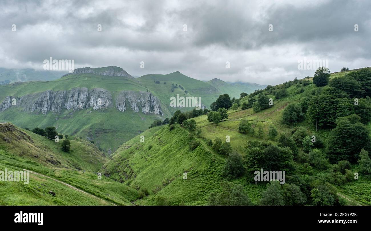 Rough mountain landscape with steep limestone slopes and green meadows ...