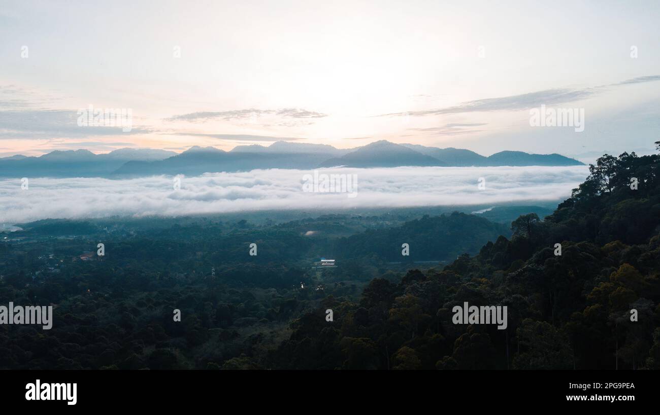 Sea clouds during golden sunrise above Titiwangsa mountains in Lenggong ...