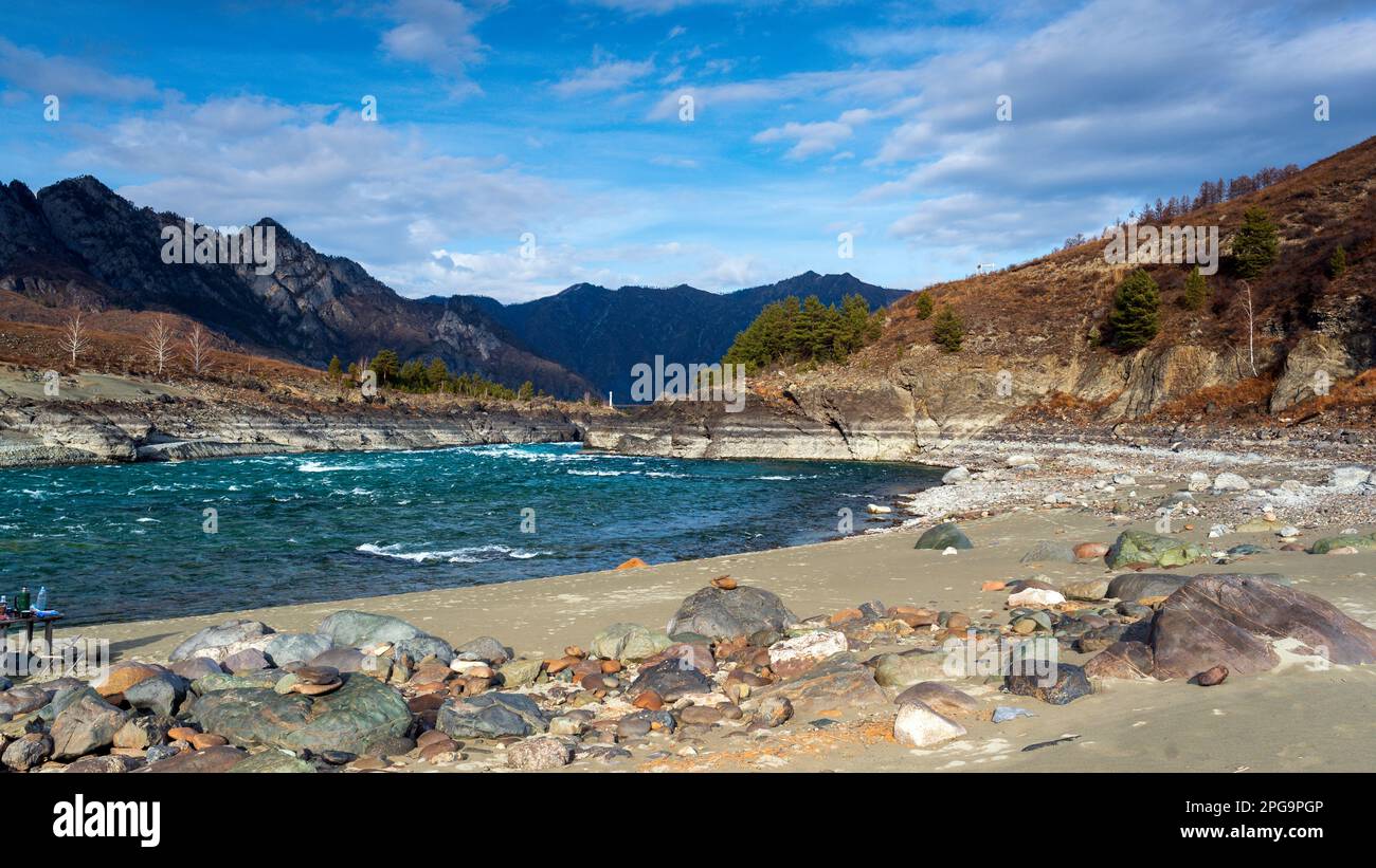 The edge of the tourist table and the stones lie on the sandy beach ...
