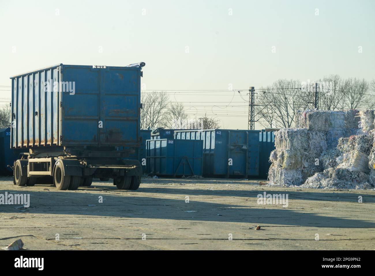 Heavy trailer parked in the recycling yard along plastic waste bales ...