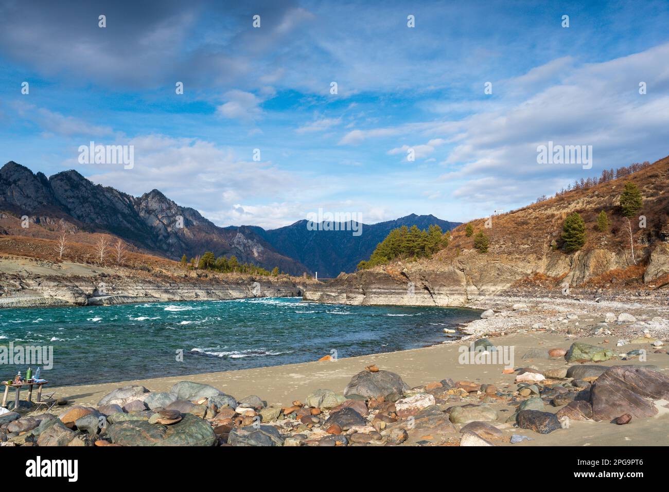 The edge of the tourist table and the stones lie on the sandy beach ...