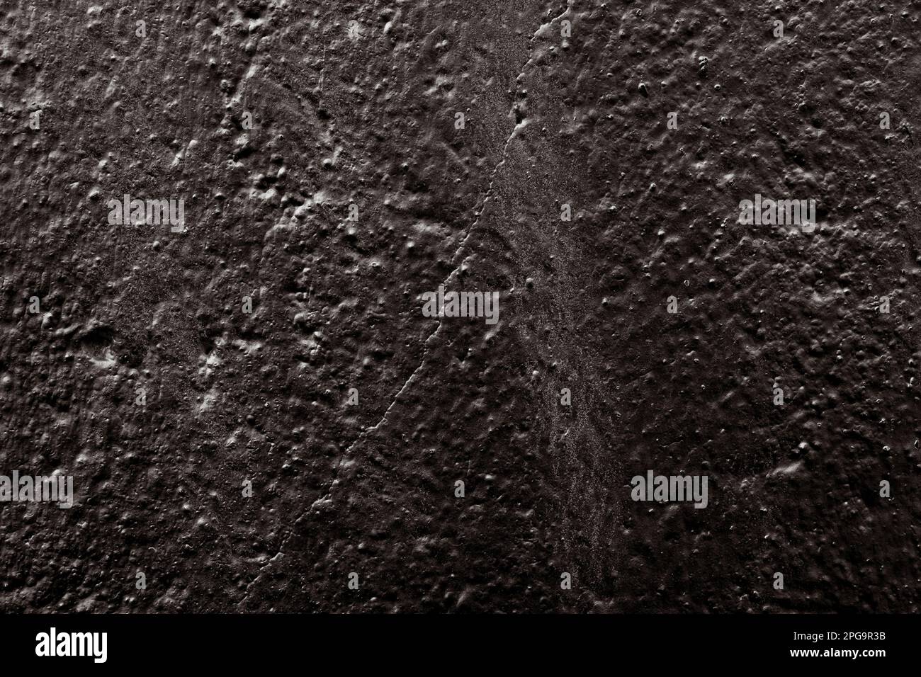 Black painted popcorn ceiling bumpy texture Stock Photo - Alamy