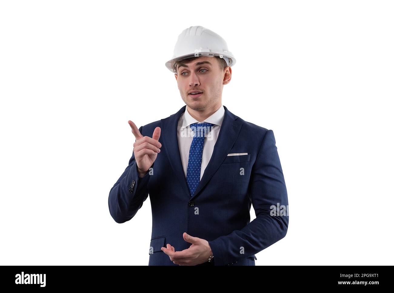Handsome man in a suit and helmet shows the emotions of solving problem ...