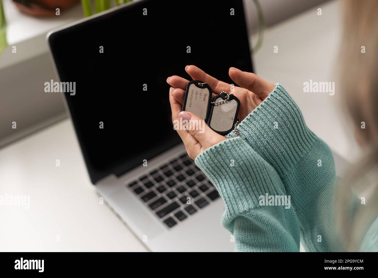 woman holding military token in hand Stock Photo - Alamy
