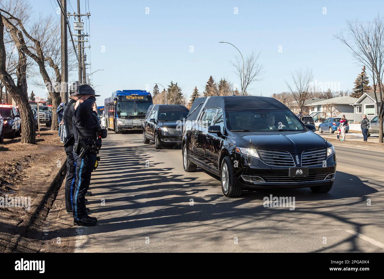 Edmonton, Canada. 21st Mar, 2023. Police salute as the procession for ...