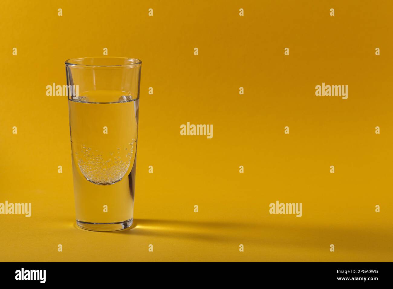 Glass of pure sparkling water on yellow background Stock Photo - Alamy