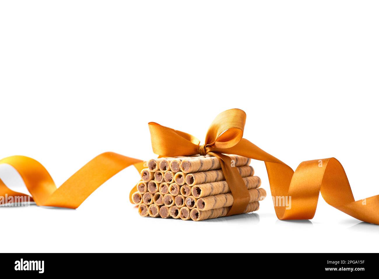 Crispy wafer rolls with chocolate are stacked and tied with a ribbon ...