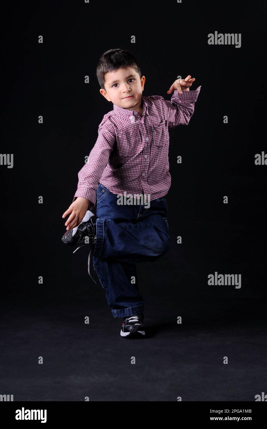 cute little boy dancing on black background Stock Photo - Alamy
