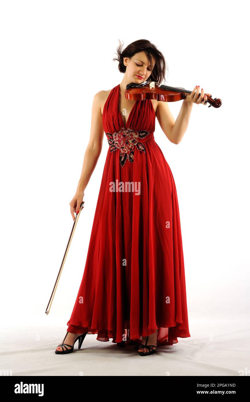 young woman in red dress playing violin isolated on white background ...