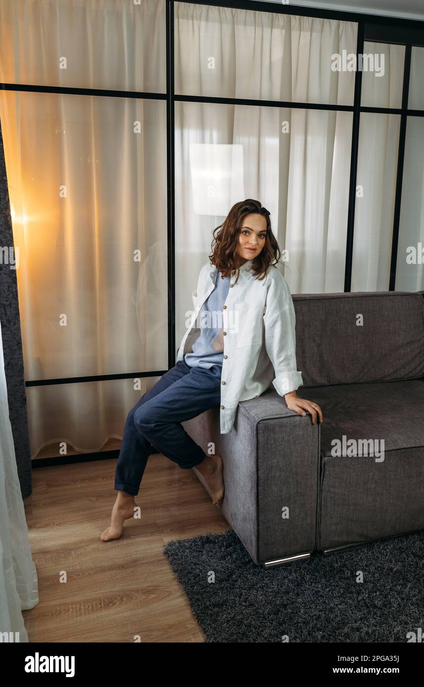 Portrait of a beautiful young woman who is sitting on the back of the ...