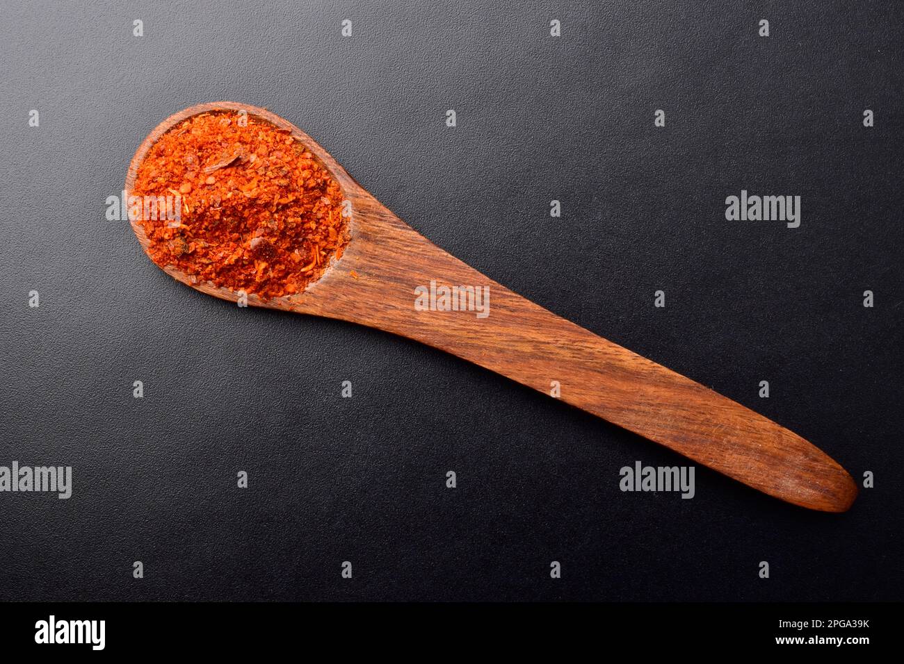 Red chilli powder in wooden spoon top view, spicy ingredient Stock ...