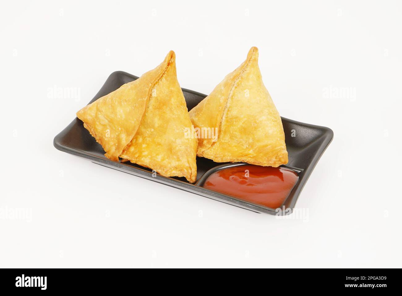 Samosa with ketchup in plate on white background Stock Photo - Alamy