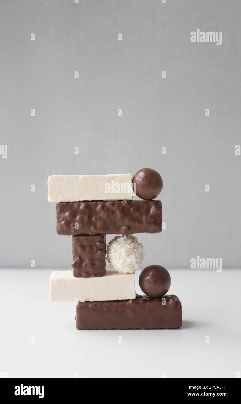 Vertical stack of many sweet snacks, balance concept Stock Photo - Alamy