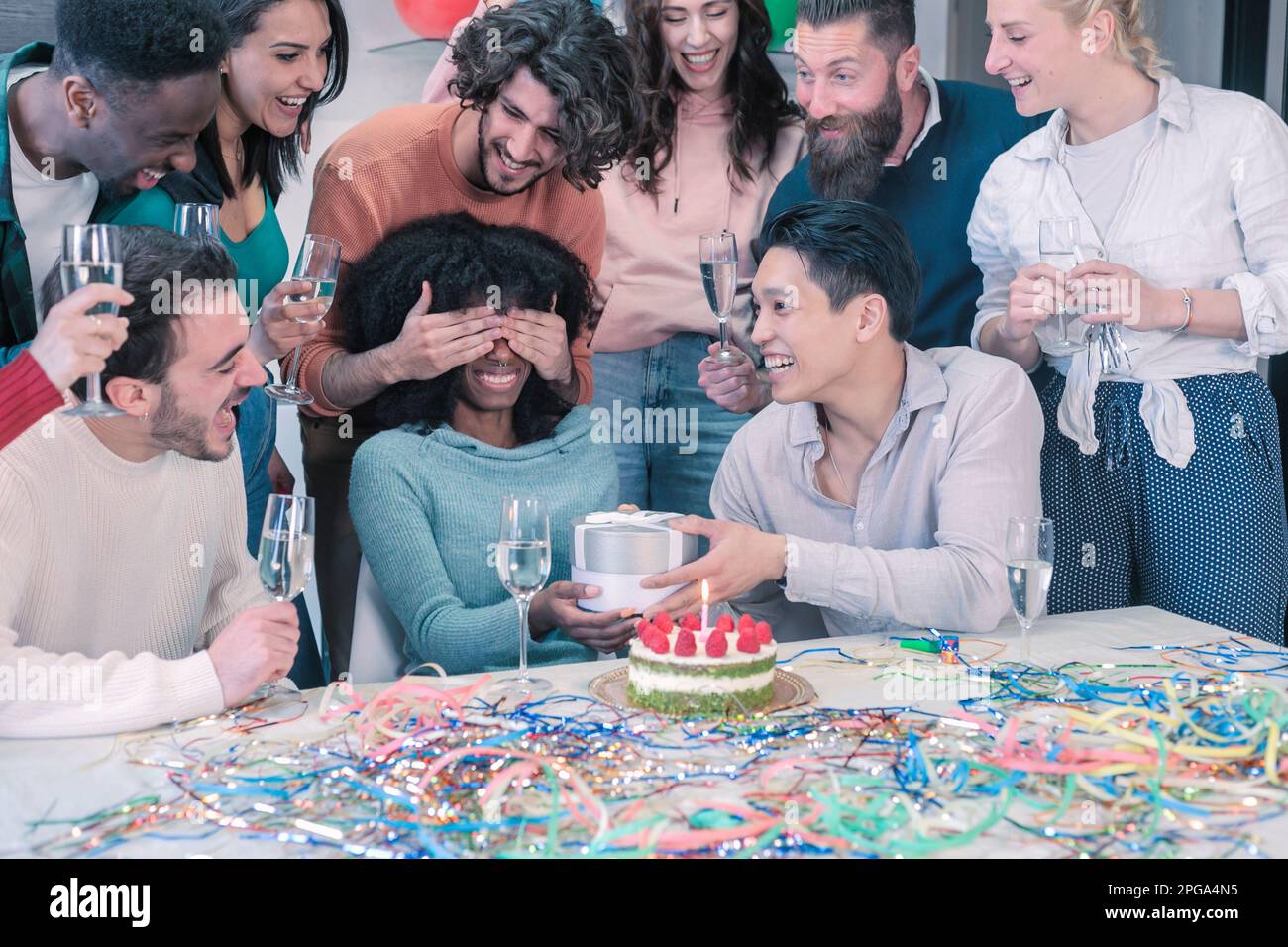Group of happy multi ethnic people celebrating birthday among friends ...