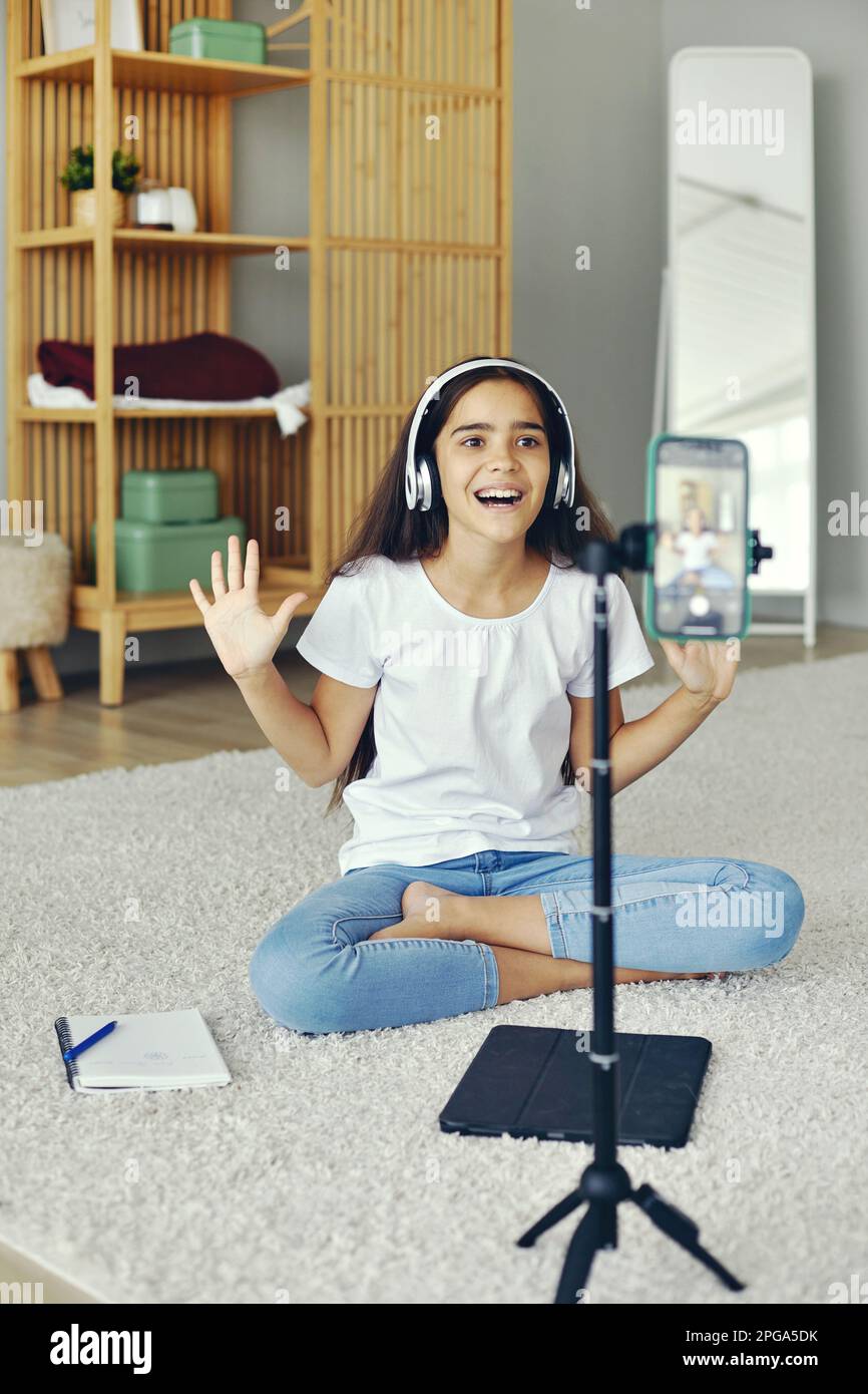 Pretty preteen 12s girl in headphones blogger record video for vlog ...