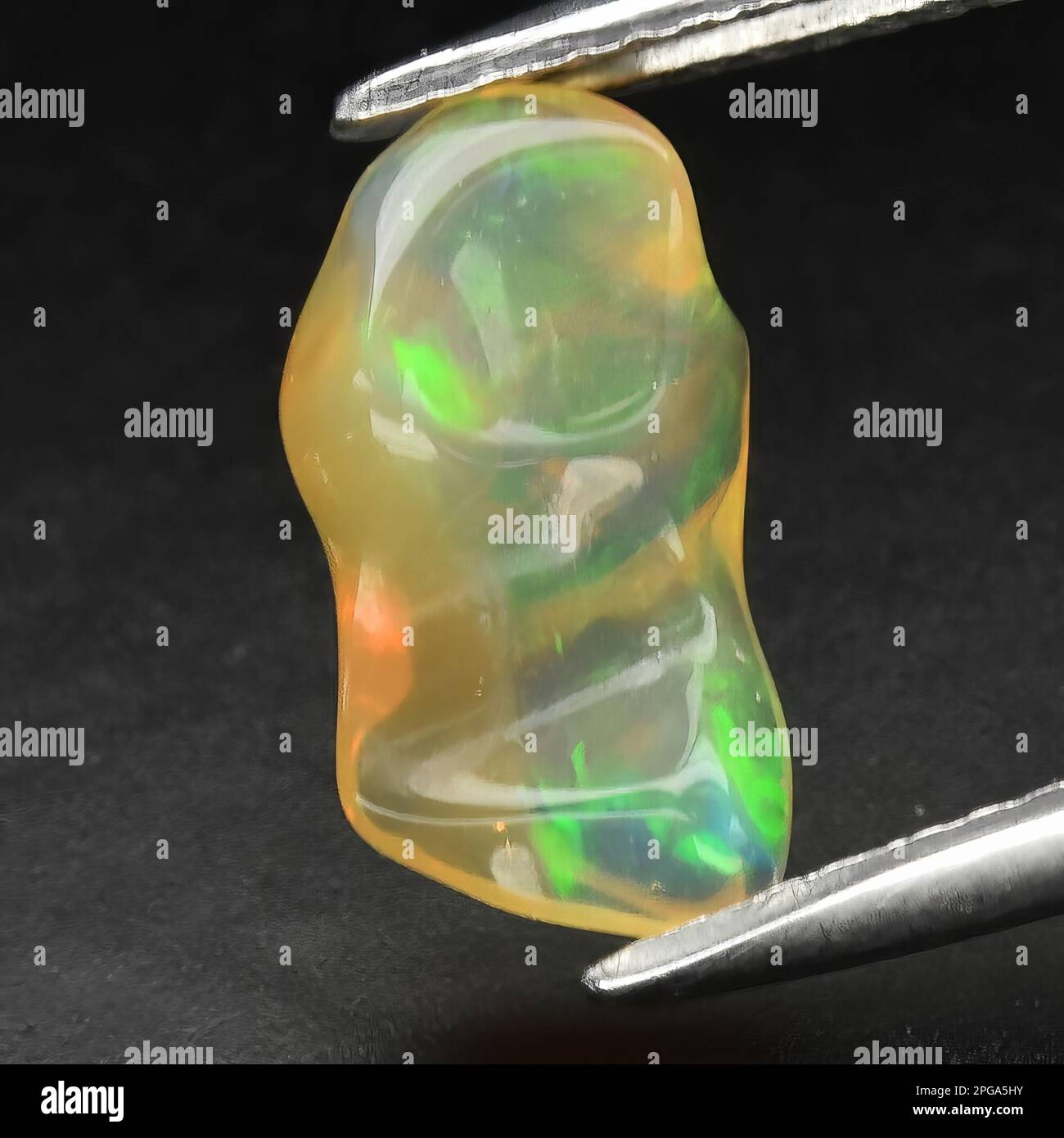 Natural precious stone opal on a black background Stock Photo - Alamy