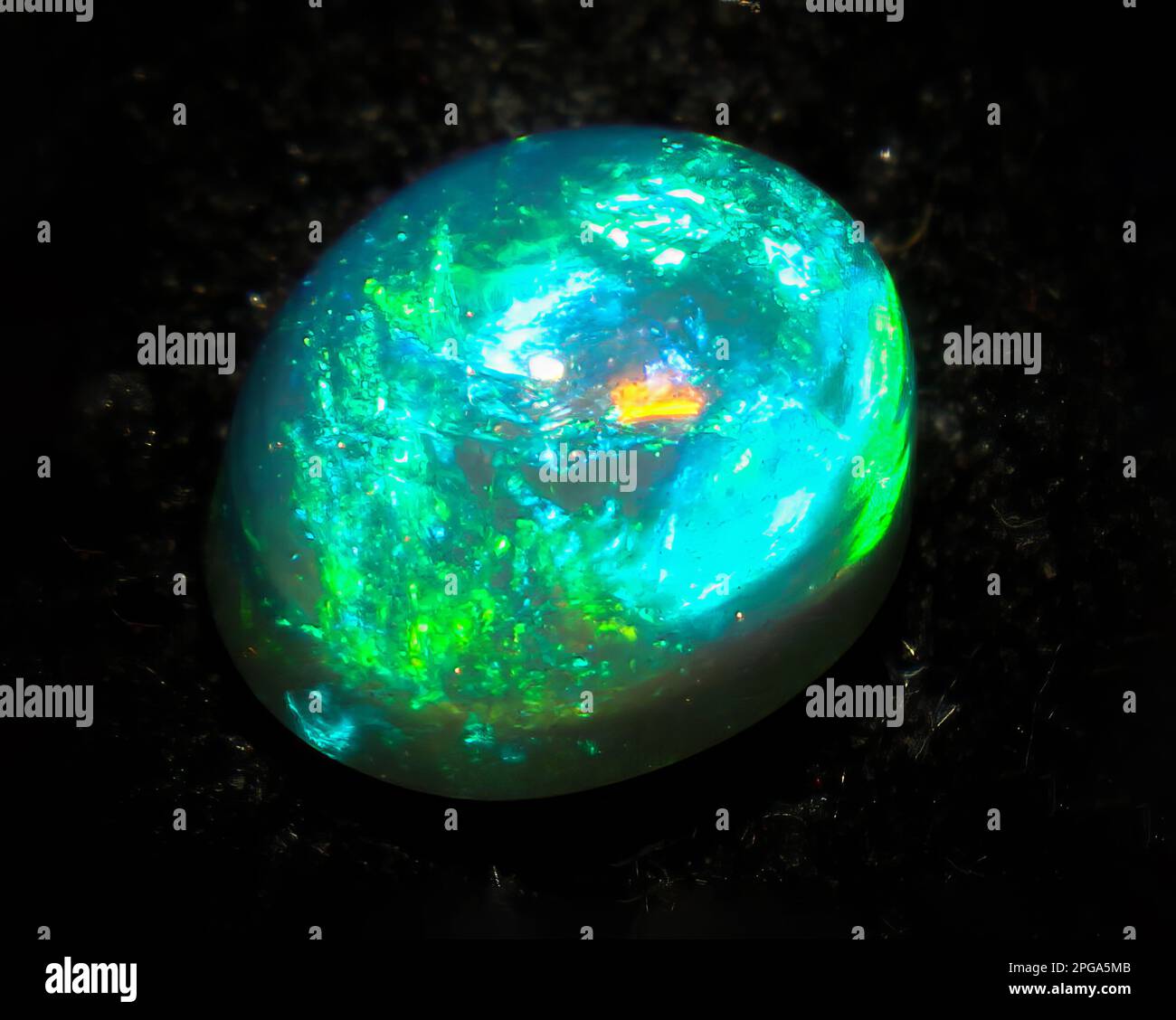 Natural precious stone opal on a black background Stock Photo - Alamy