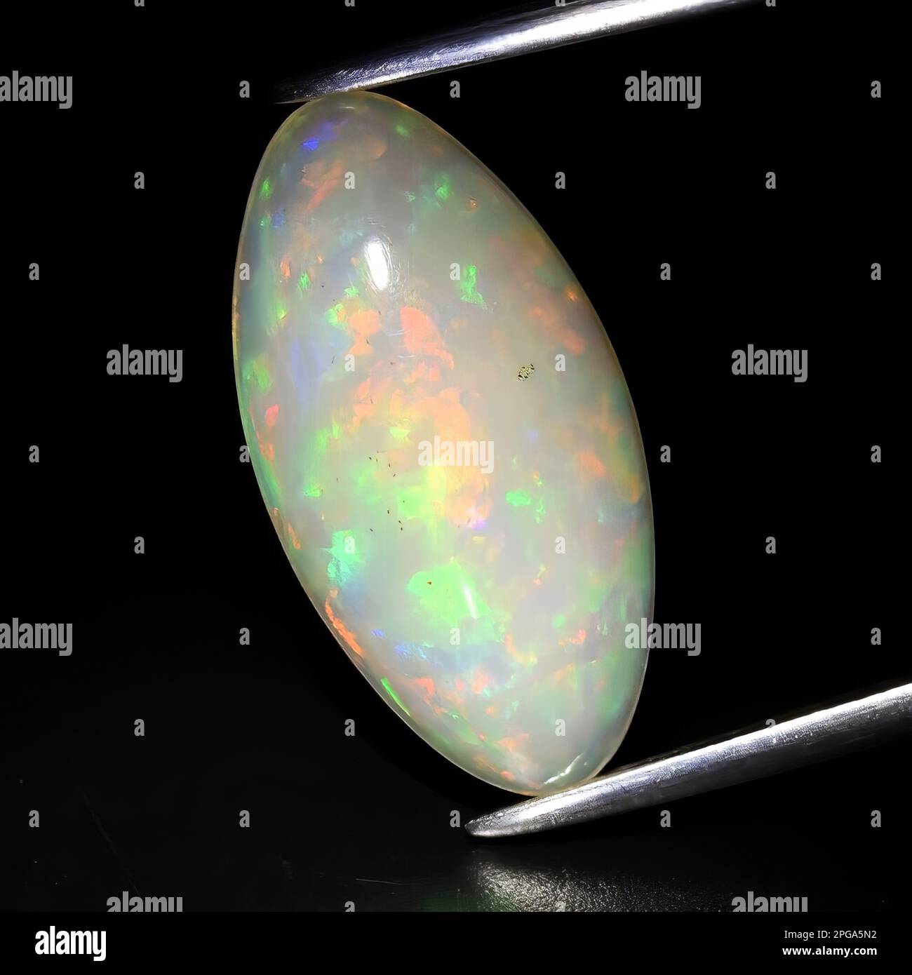 Natural precious stone opal on a black background Stock Photo - Alamy