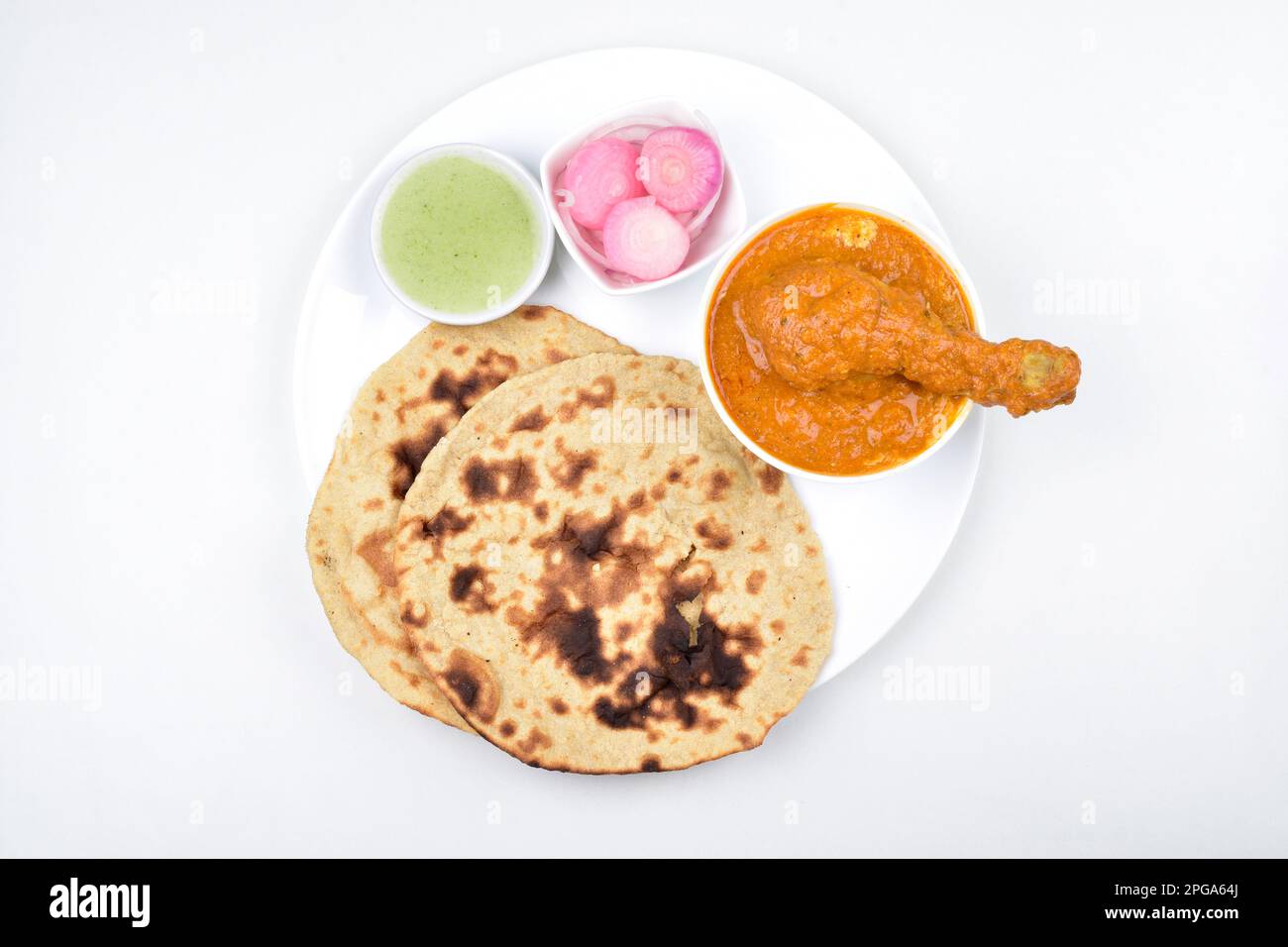 Top view of butter chicken with tandoori chapati in plate isolated on ...