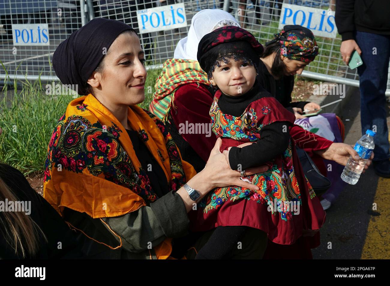 Diyarbakir, Turkey. 21st Mar, 2023. A Kurdish woman with her baby waits ...