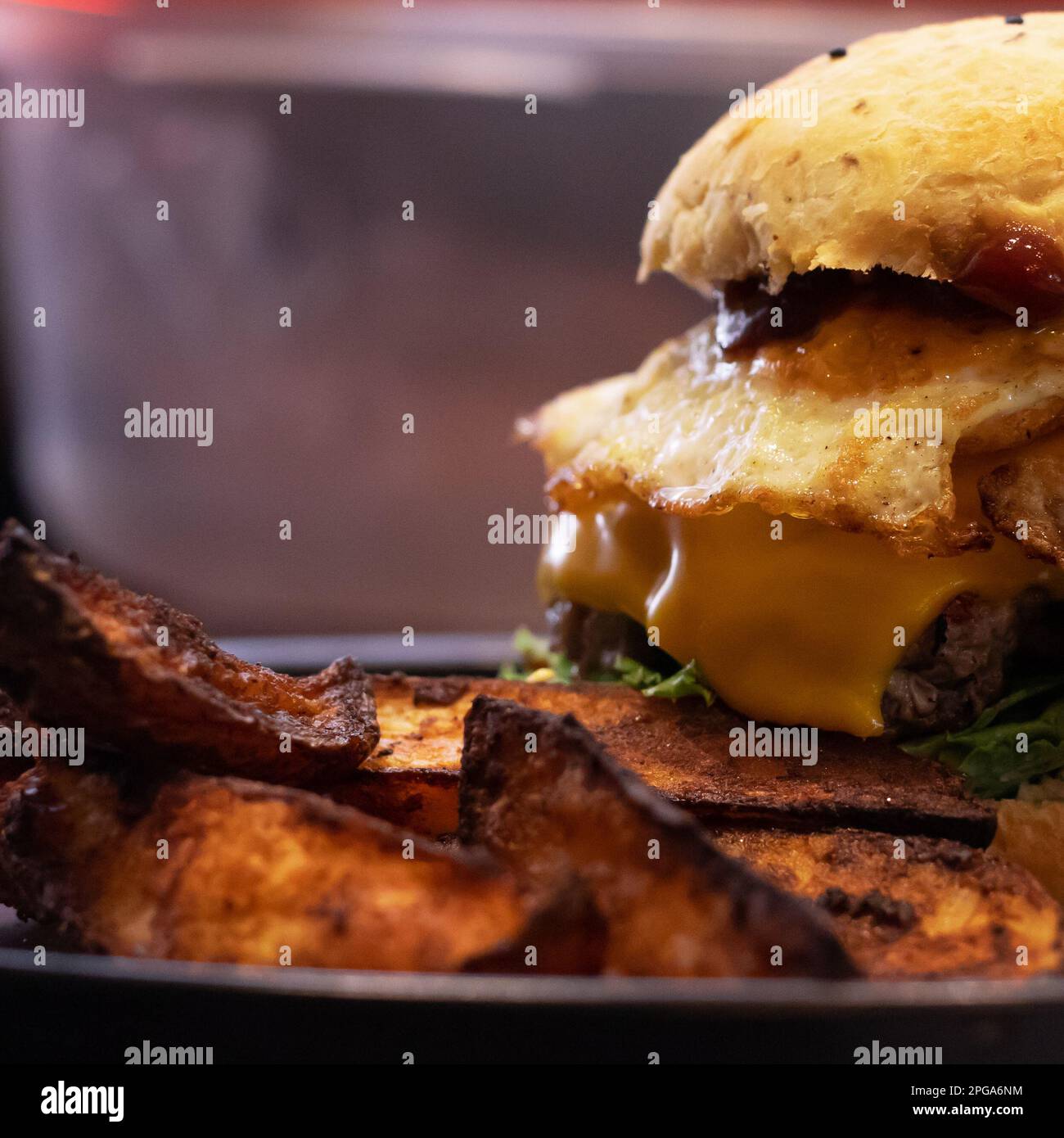 Burger served with french fries close-up blurred background Stock Photo ...