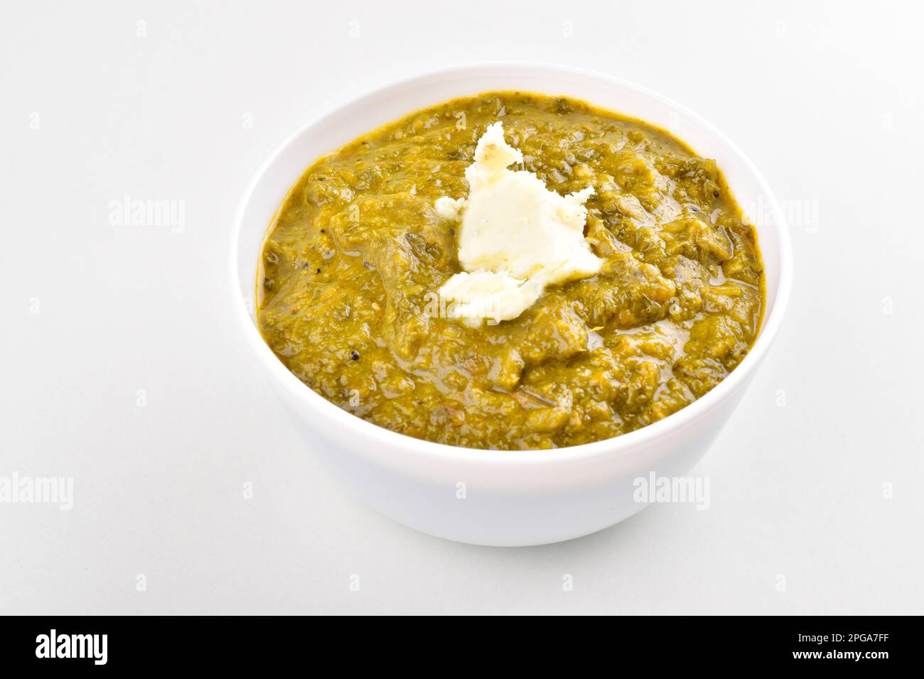 Sarson saag in bowl with white butter on white background Stock Photo ...