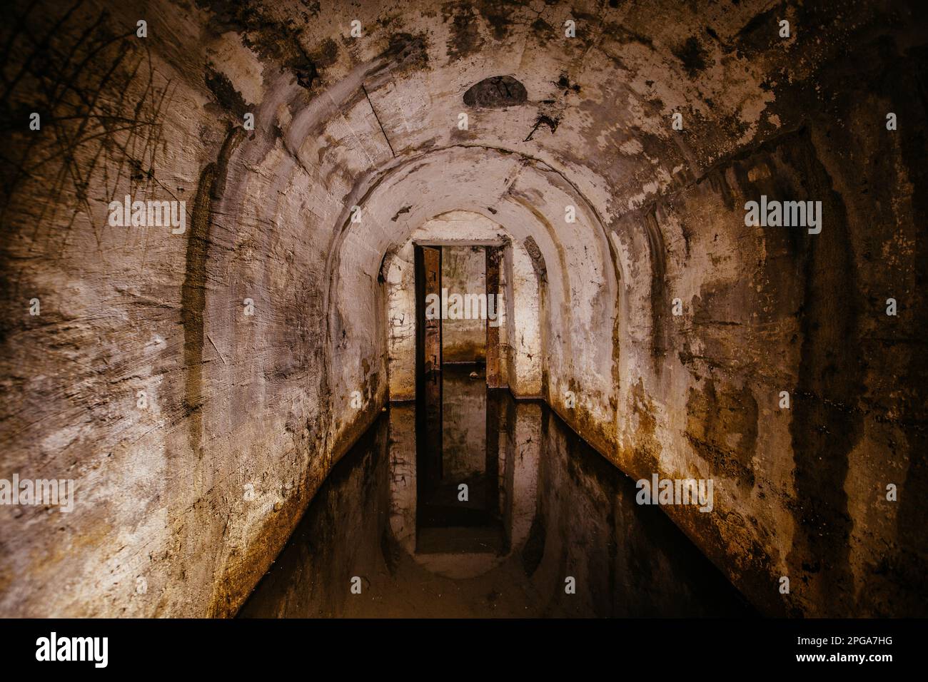 Flooded tunnel with water reflection in abandoned bunker Stock Photo ...