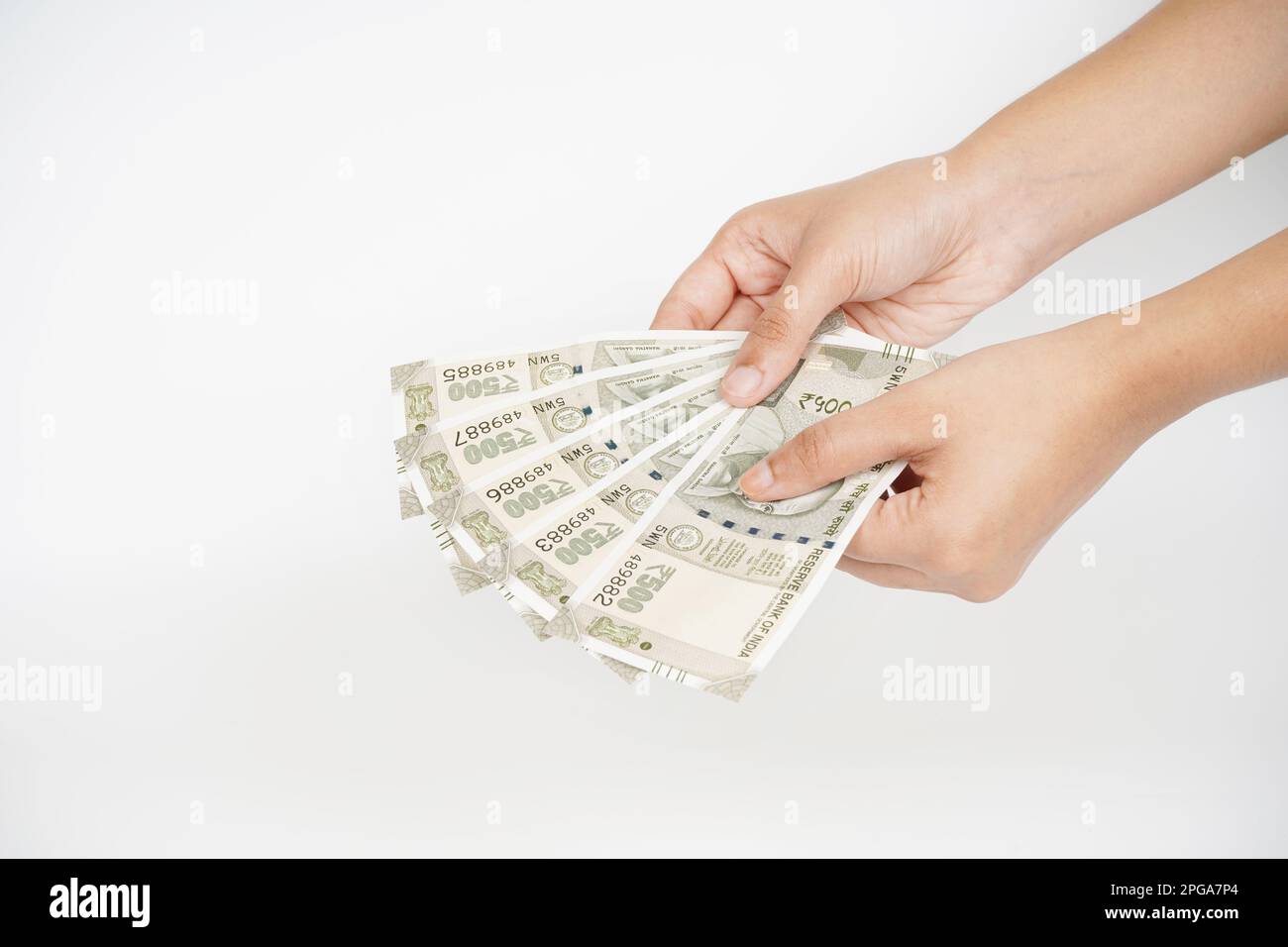 Indian currency note in hand on white background Stock Photo - Alamy