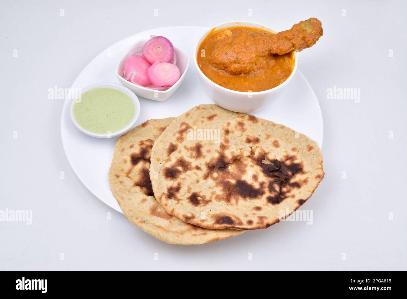 Butter chicken with tandoori roti served with pickled onion and mint ...