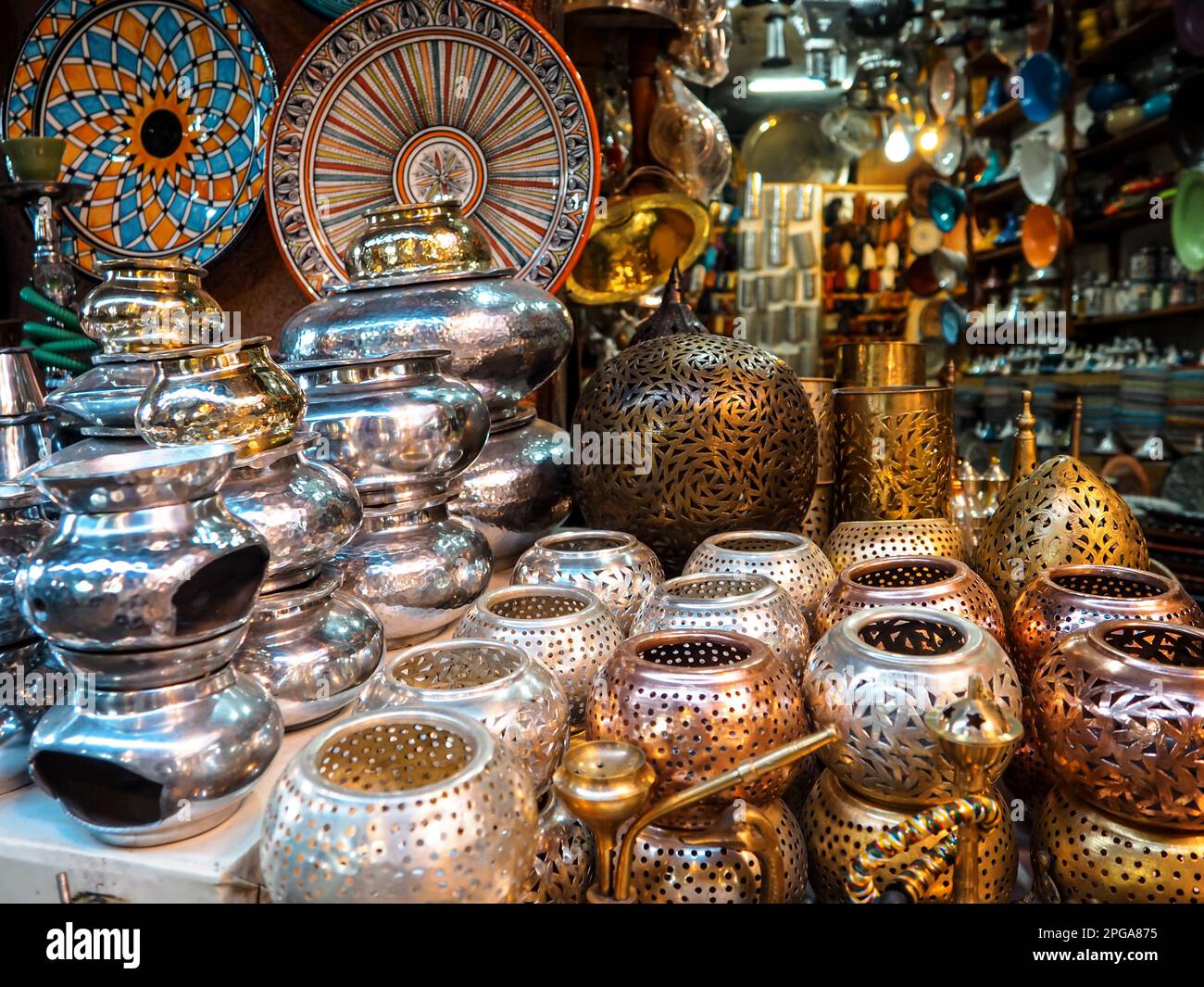 Oriental pattern brass candle lamps on display at souk - traditional ...