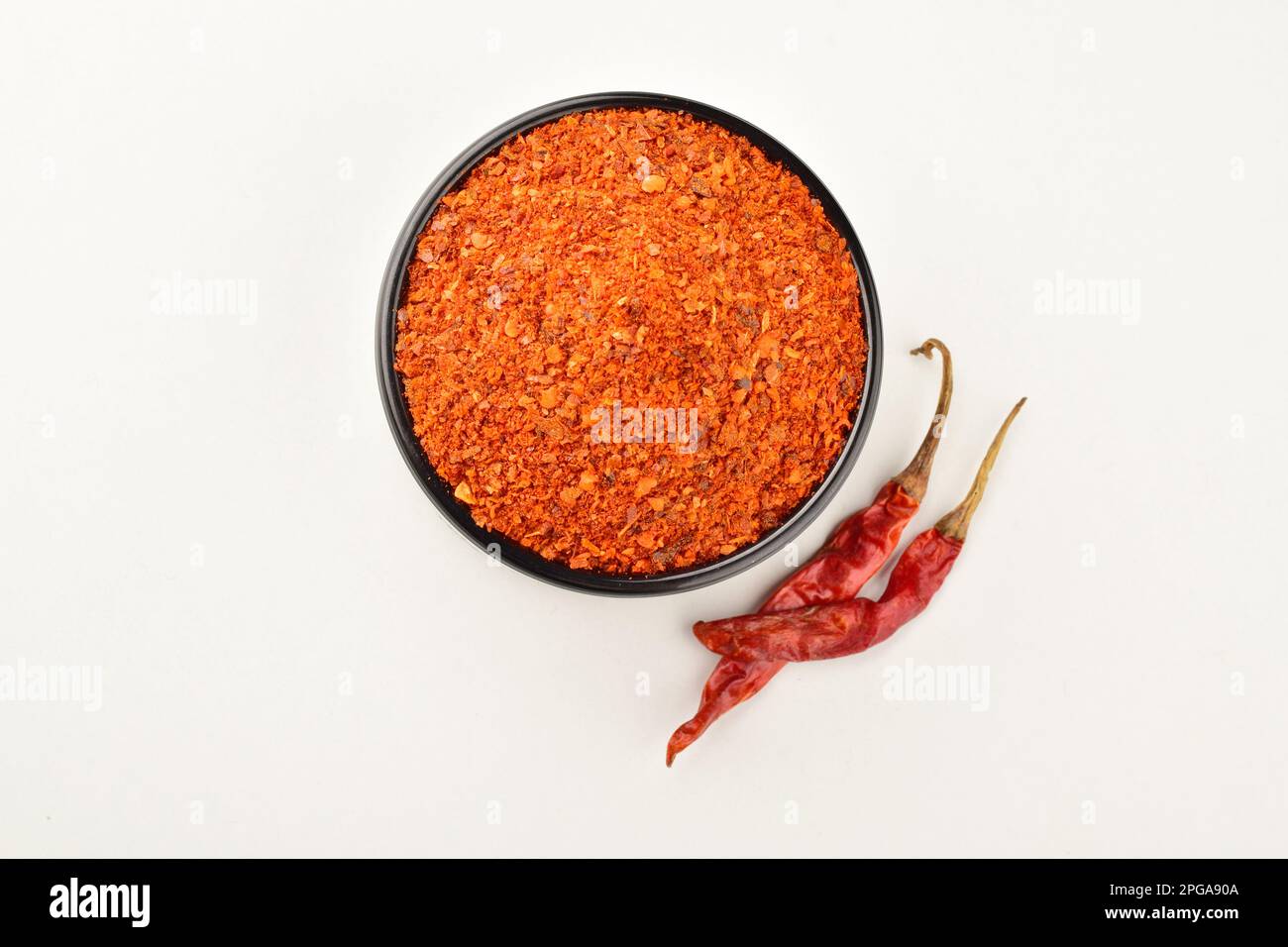 Ground chili powder with dry cayenne chilli isolated on white ...