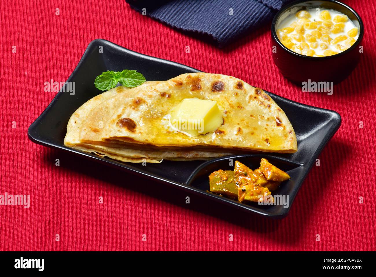 Stuffed aloo paratha served with raita and achar, healthy indian ...