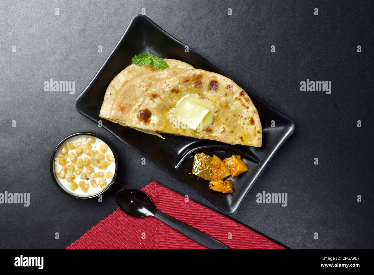 Top view of butter paratha with raita and pickle, healthy indian food ...