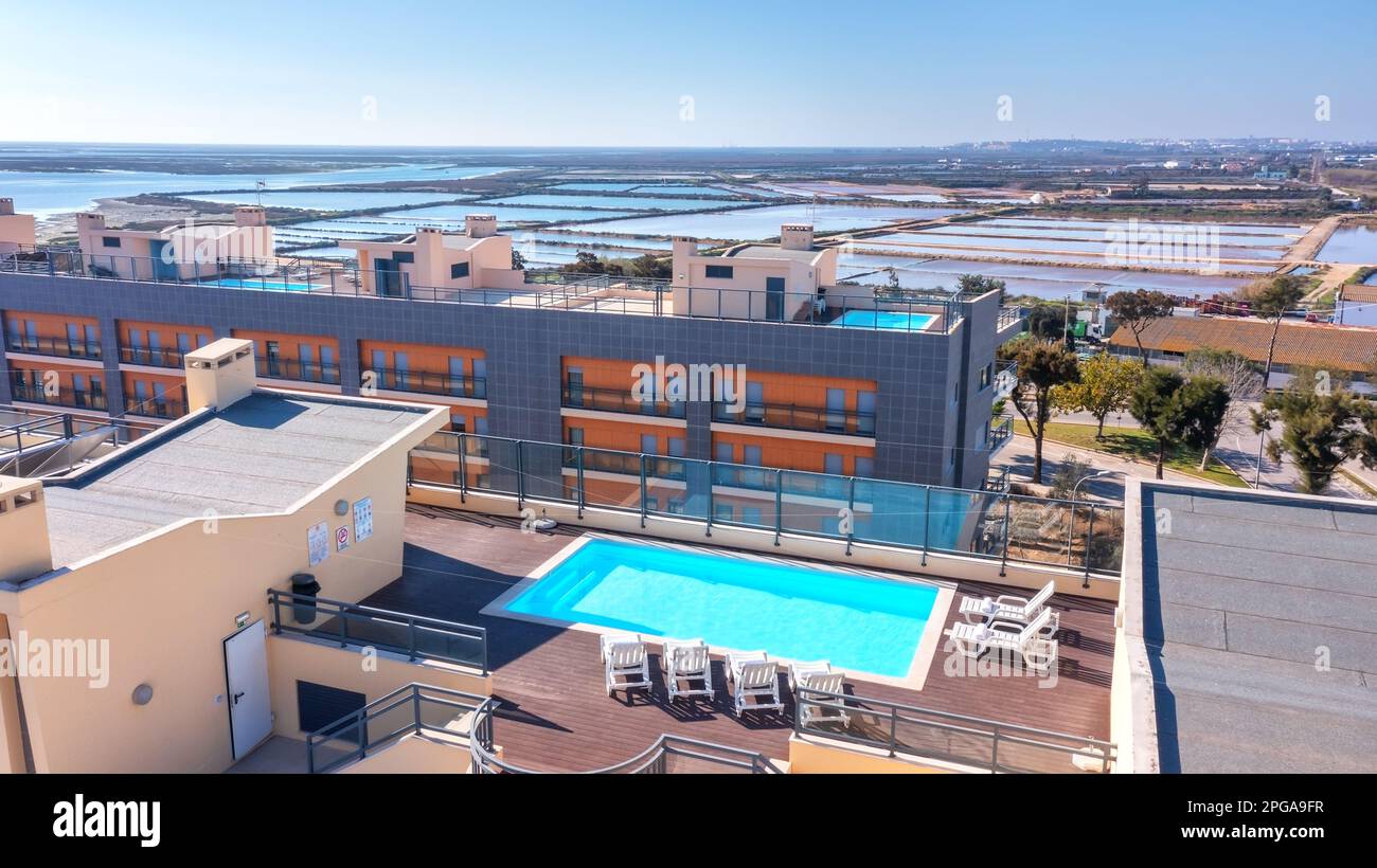 Aerial view of a high-rise building with a rooftop swimming pool for ...