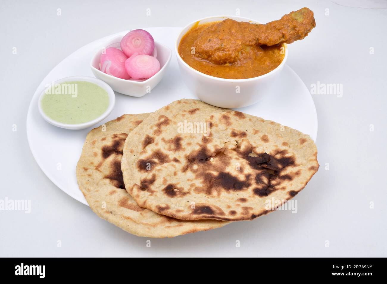 Butter chicken and roti in plate on white background Stock Photo - Alamy